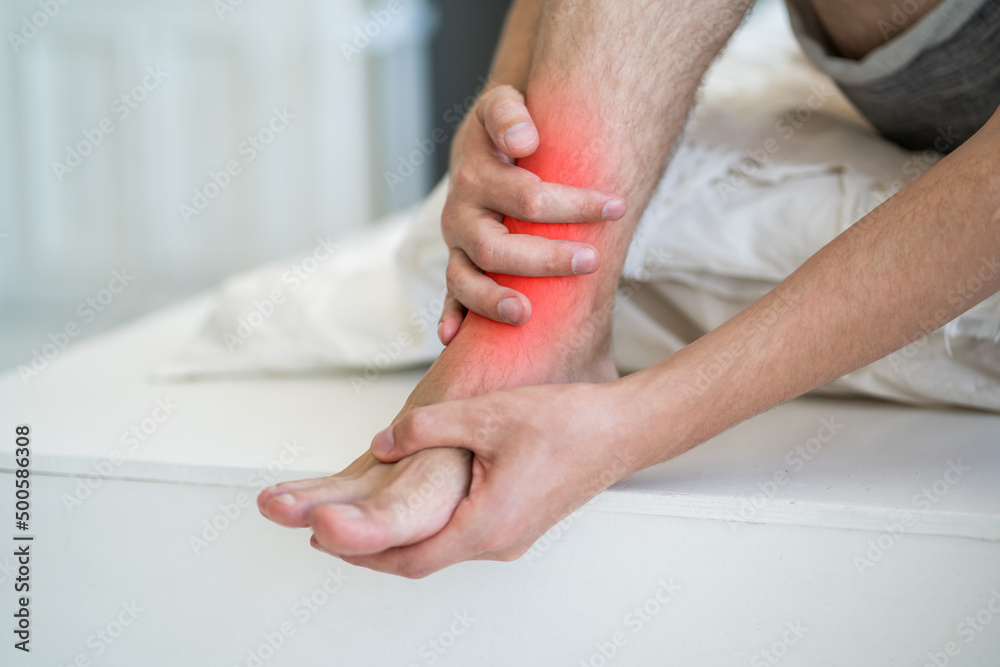 Joint inflammation, foot pain, man suffering from feet ache at home ...