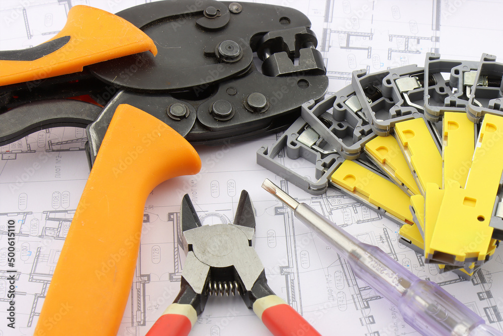 Tools for electrical installation on a close-up schematic diagram ...