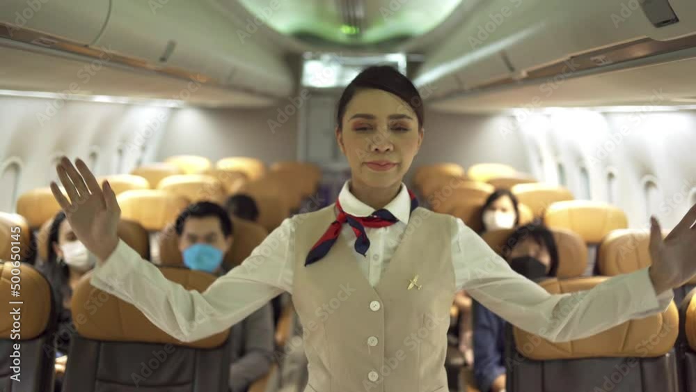 Cabin crew is show the steps throughout the safety on board. She's ...