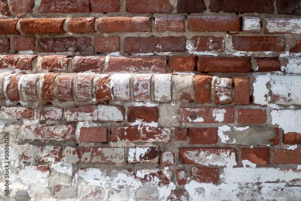 Fragment of old brickwork, close-up plan. A wall of red brick. Potholes ...