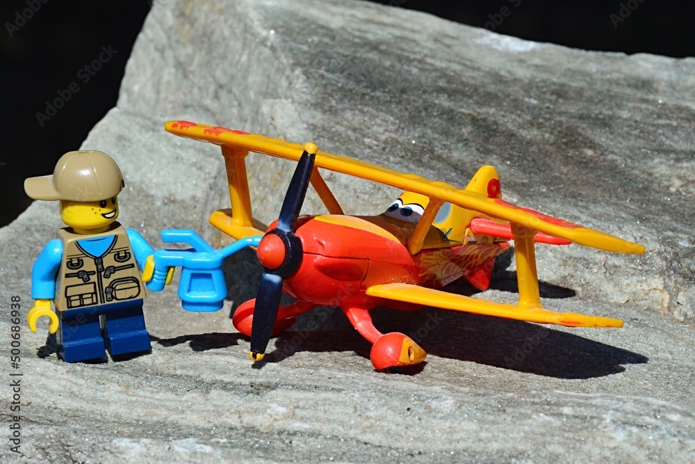 LEGO City little boy with baseball cap adding oil to biplane die cast ...