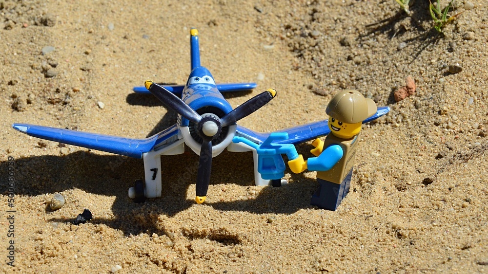 LEGO City boy figure with baseball cap adding oil to propeller parts of ...