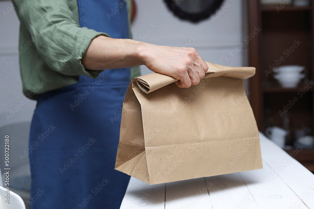 Male hand giving blank paper bag in a zero waste shopn Shop assistant ...