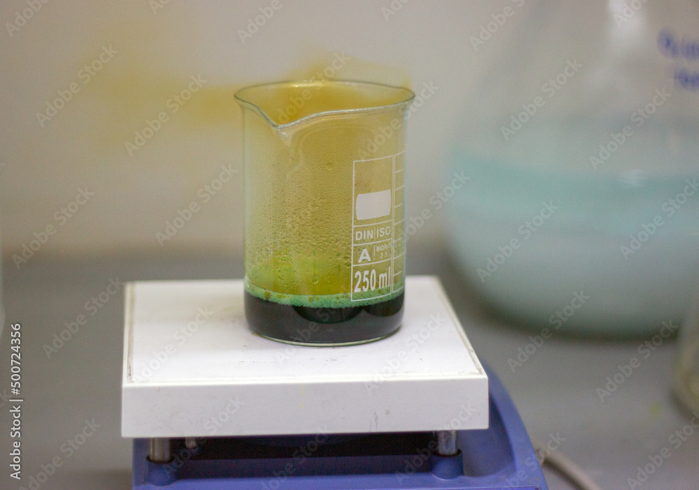 Yellowish fumes emery from the reaction occurring in the beaker. The ...