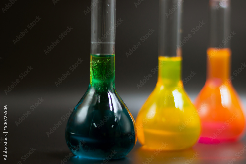 Close-up picture of colorful liquids in the volumetric flask. Chemical ...
