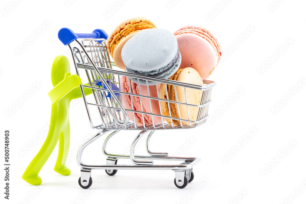 Green plastic toy abstract figure of man pushing full shopping cart ...