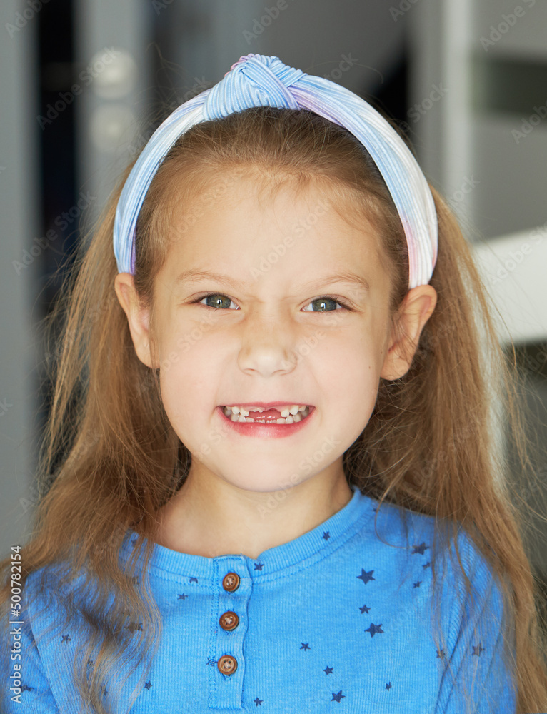 Toothless child. Cute little girl smiles broadly. The first milk tooth ...
