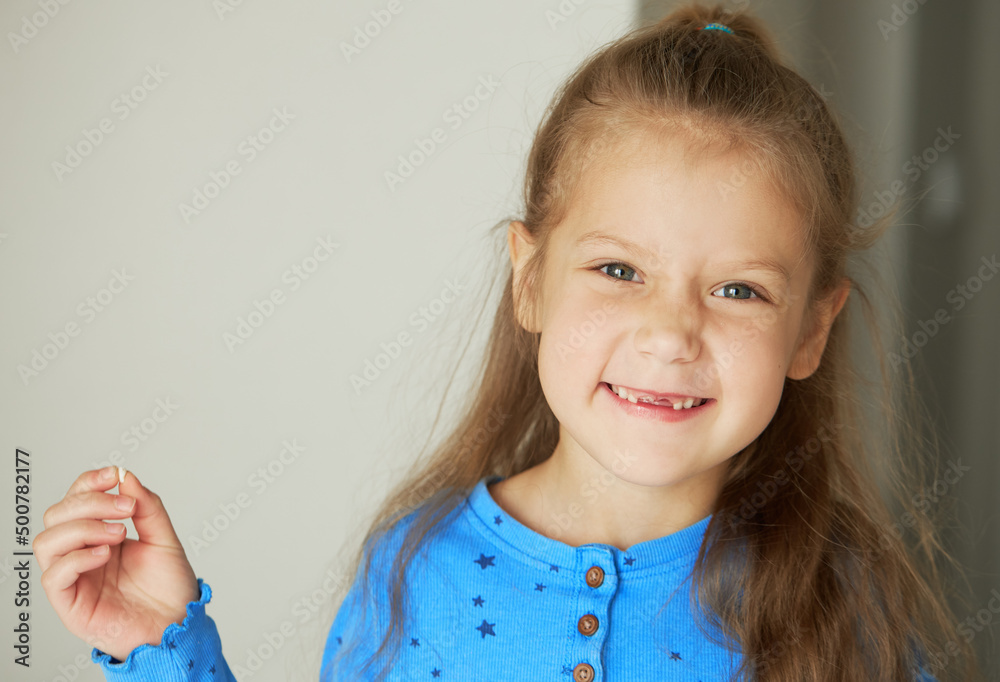 Toothless child. Cute little girl smiles broadly. The first milk tooth ...