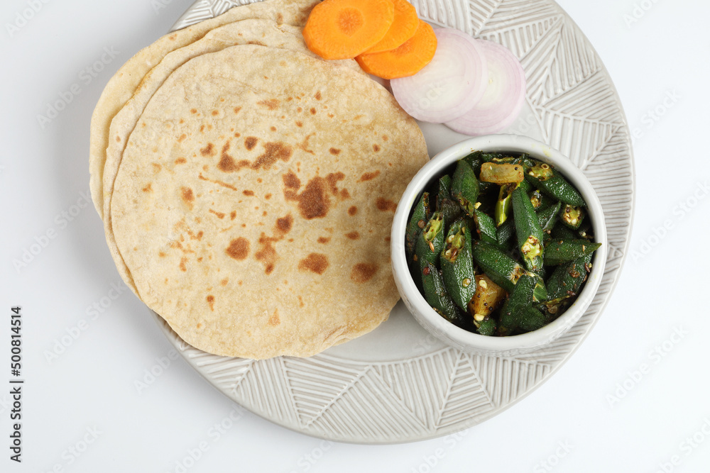 Bhindi masala or ladies finger fry served with indian roti chapati or ...