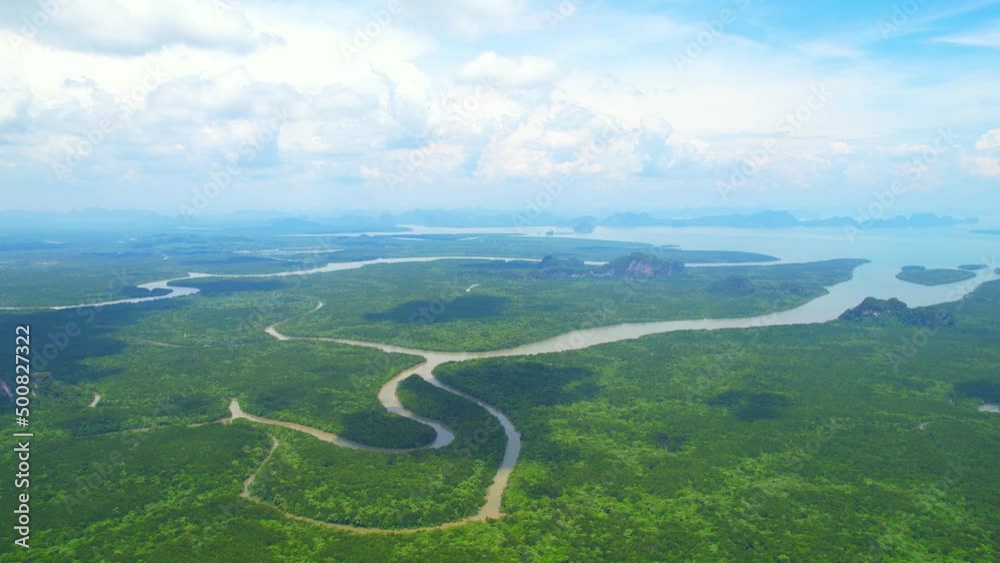 Drones are flying over winding rivers and large mangrove forests near ...