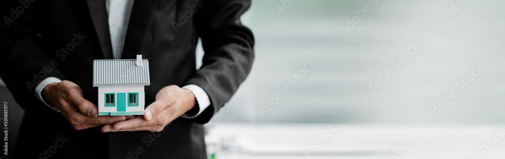 Person holding small house model, Real estate agent offer house ...