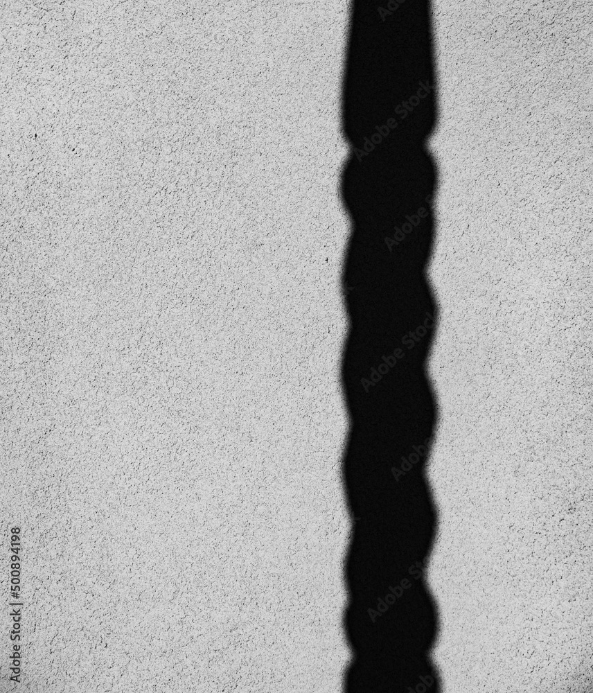 black and white of shadow of turned or curved pillar or column on ...