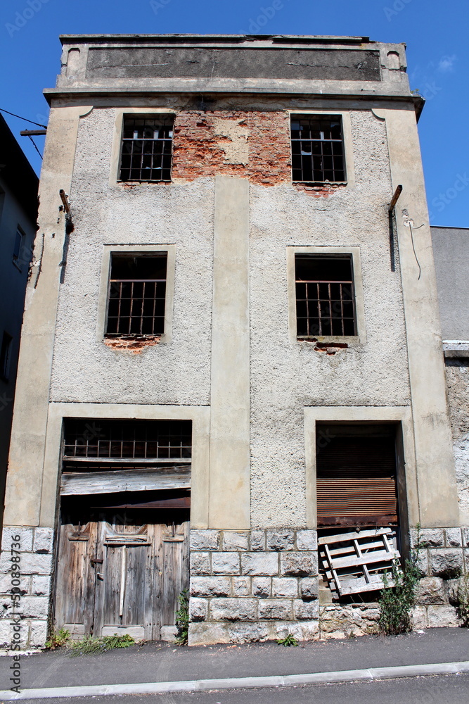 Narrow abandoned very old red bricks industrial building on traditional ...