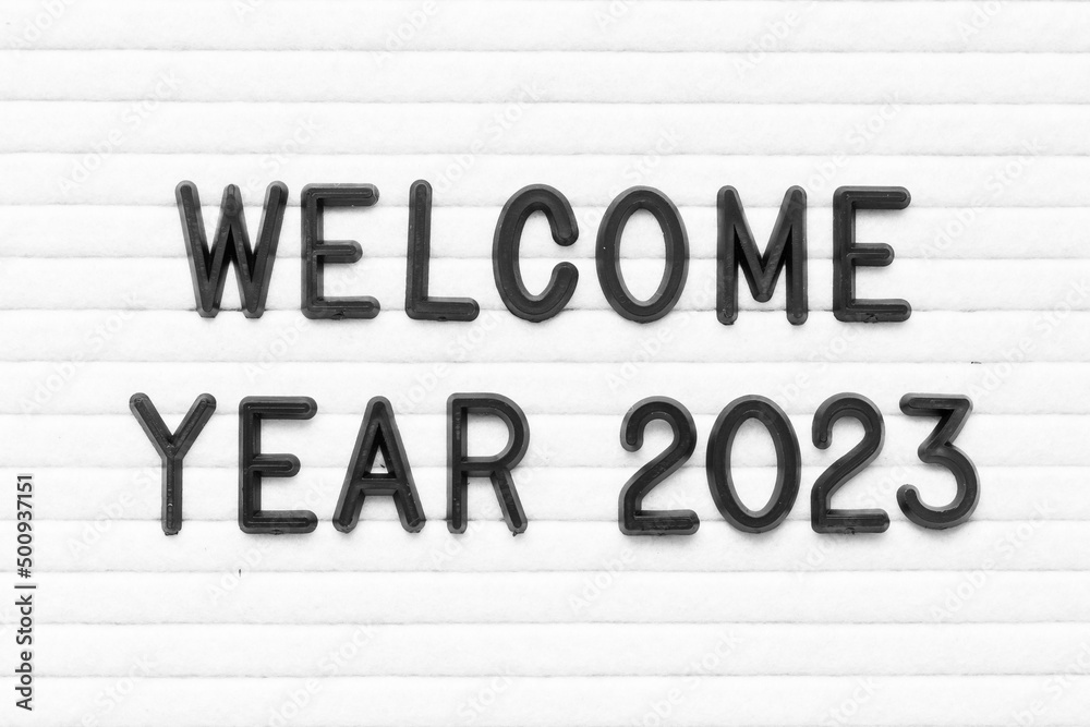Black color letter in word welcome year 2023 on white felt board ...