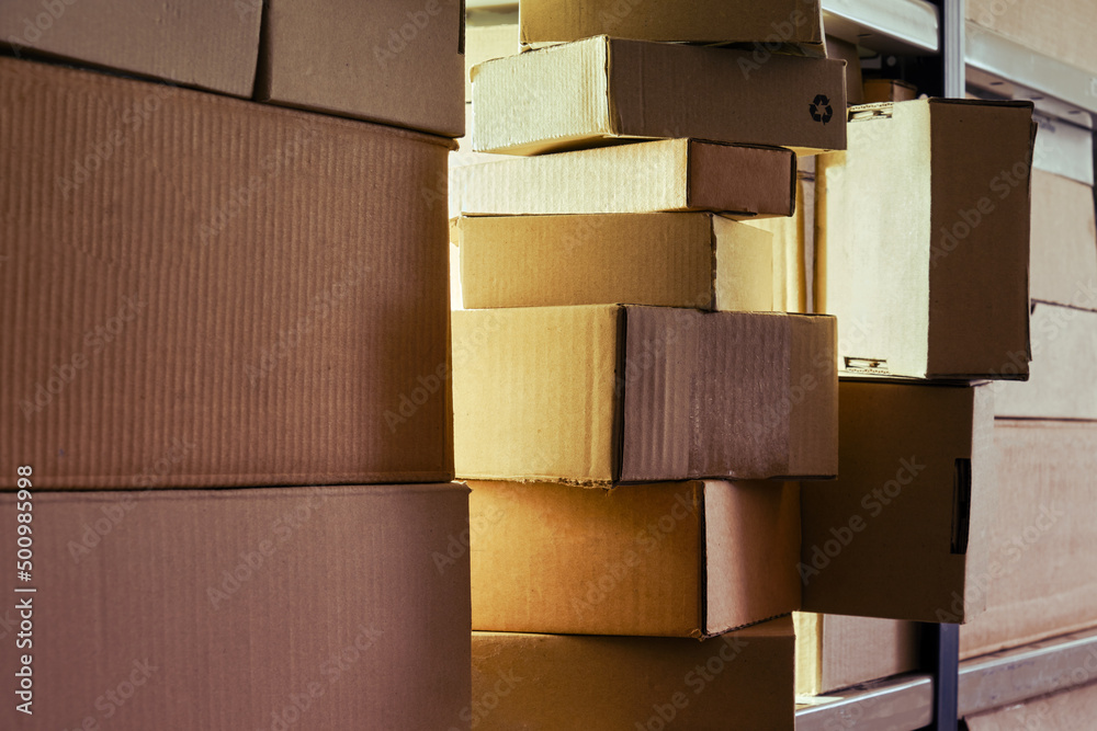 Warehouse overflowing with boxes of goods and postal parcels. Cardboard ...