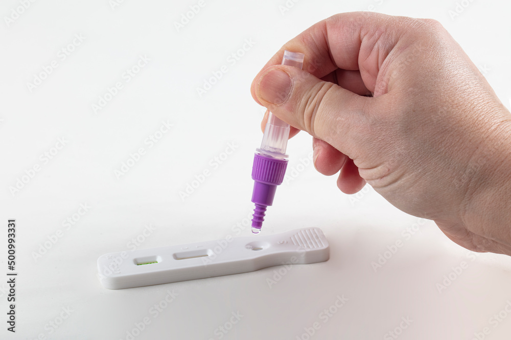 ATK SARS Cov 2 coronavirus rapid antigen test nasal kit. A woman doing ...