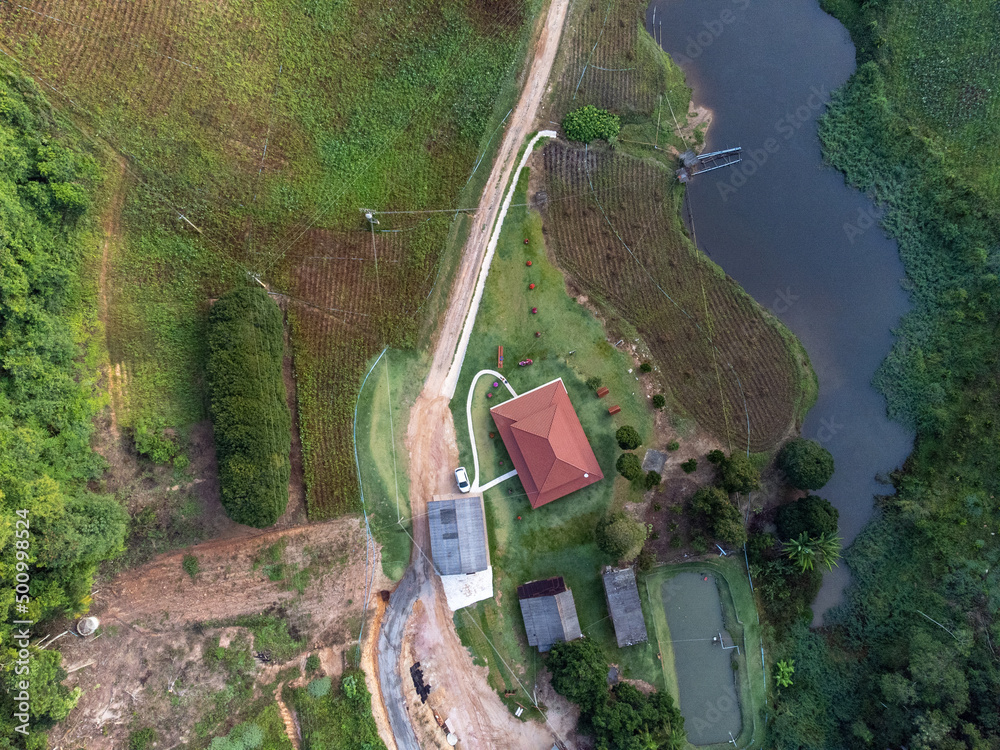 Small country town with food production on plantations, small houses ...
