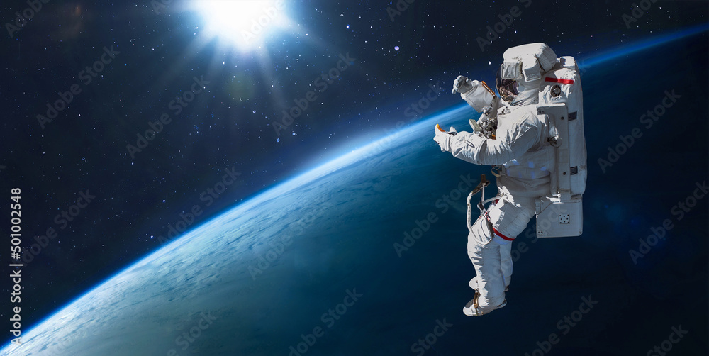 Astronaut in outer space on orbit of Earth planet. Sky and clouds ...