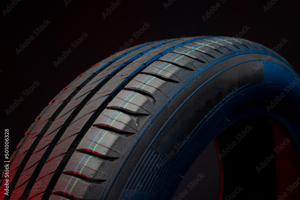 New car tire. Road wheel on dark background. Summer Tire with ...
