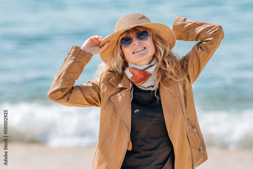 Poster dressed middle-aged woman enjoying on the beach – Wall Art ...