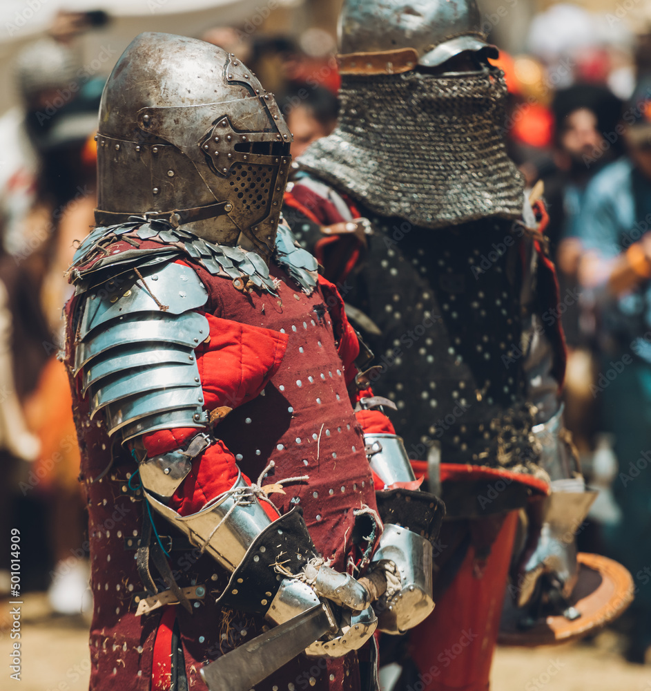 Pitch battle of medieval knights, using metal armor, axes, swords and ...