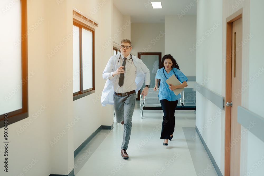 Team of medical professionals running in hospital corridor. Stock Photo ...