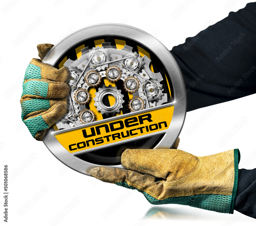 Gloved hands holding an under construction sign with metal cogwheels ...