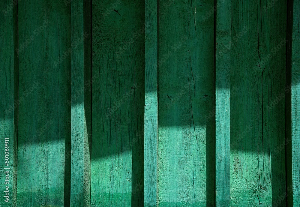 structure of a green wooden wall panel in close up outdoors with shadow ...