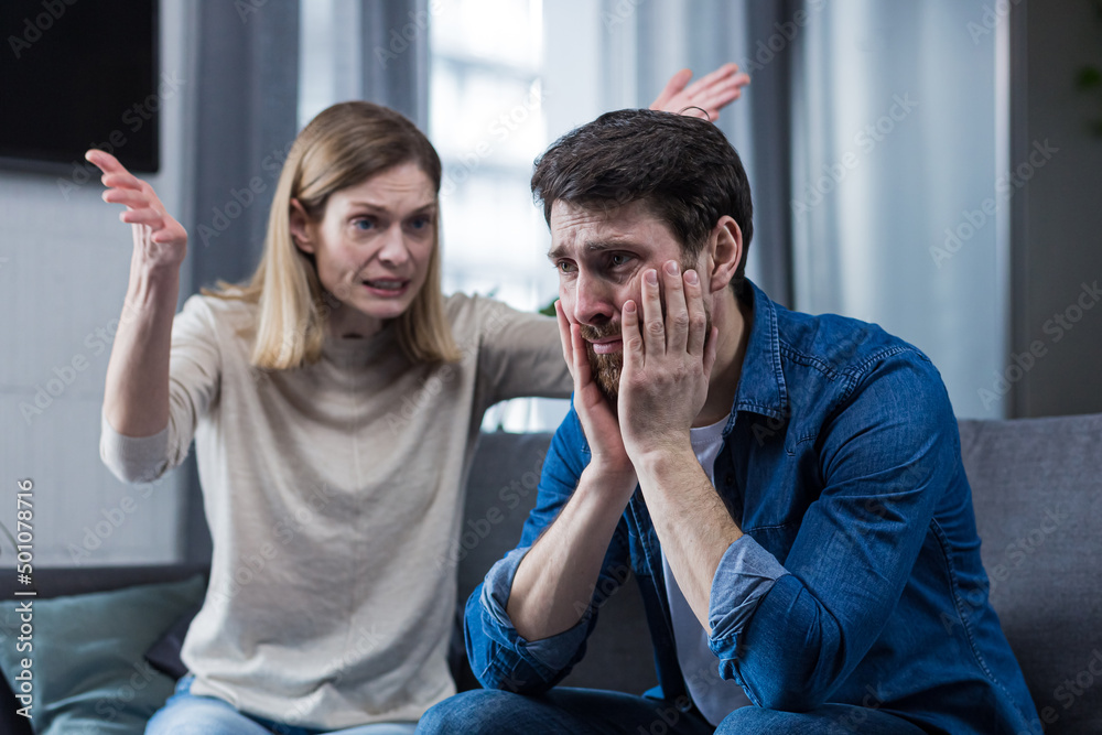 Family quarrel, woman quarrels and yells at the loser's husband, couple ...