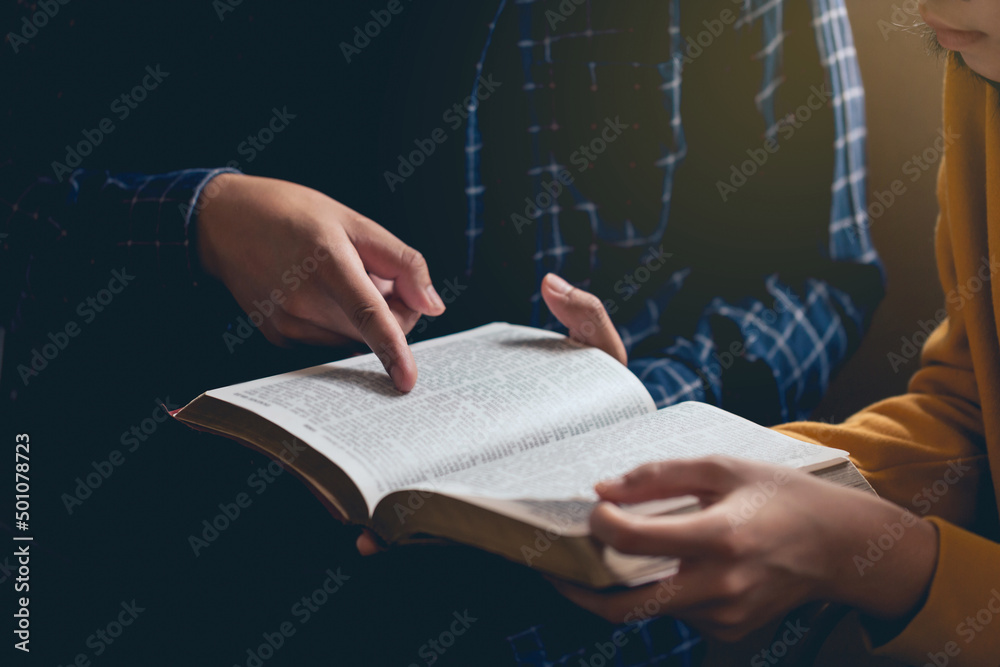 Male reading the Holy Bible by pointing to the character and sharing ...