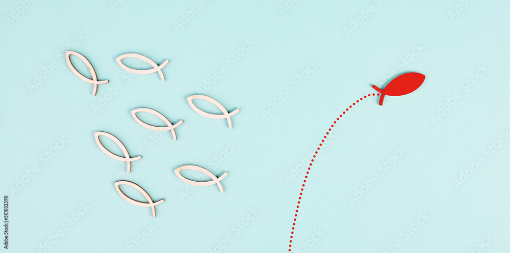 One fish is the leader of the group, leadership and teamwork concept ...