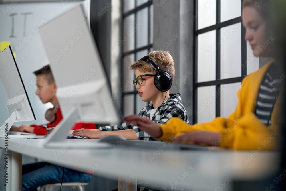 School kids using computer in classroom at school Stock Photo | Adobe Stock