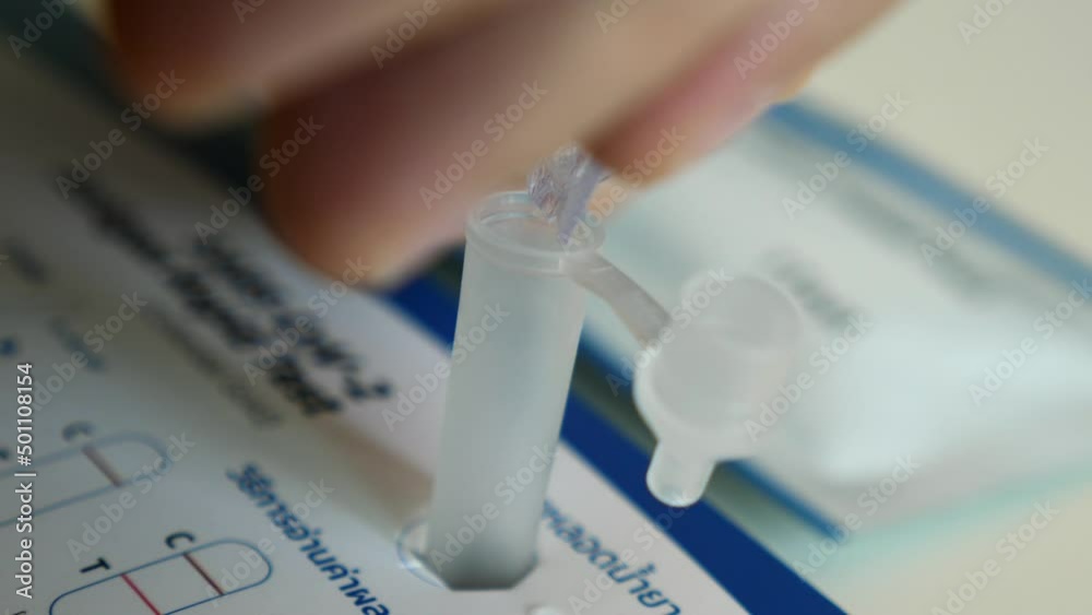Man hand squeezes liquid in a plastic tube to test for coronavirus at ...