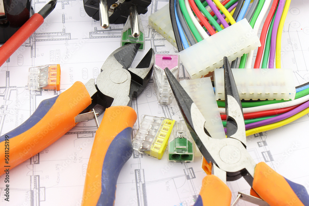 Tools for electrical installation on a close-up schematic diagram ...