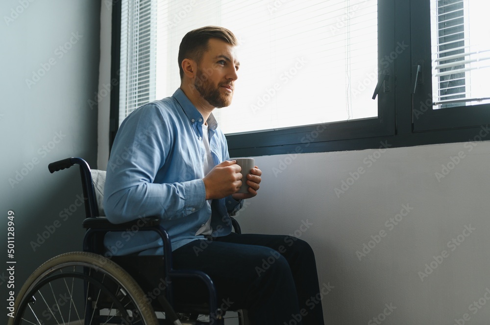 Disabled Person Sits in Wheelchair Against Window. Serious Sad ...