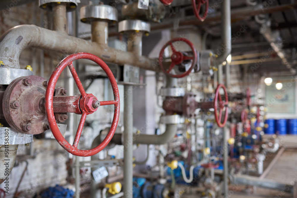 Close-up at pipeline valve which is using to control production process ...