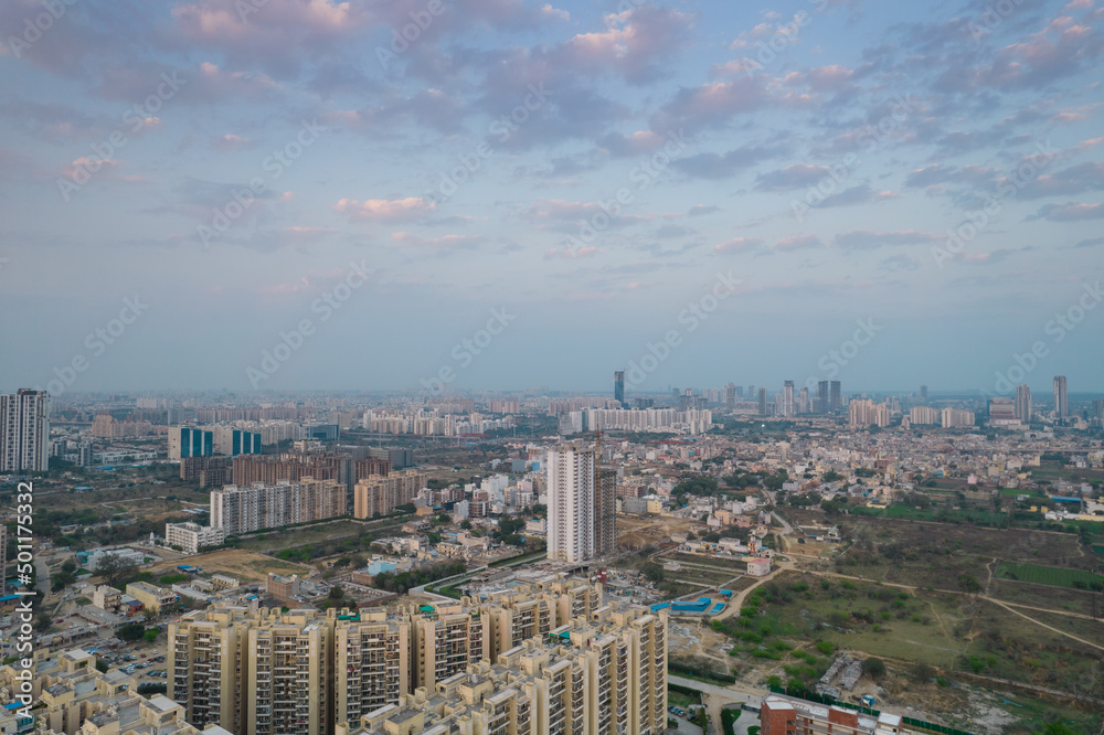 aerial drone shot passing over a building with homes, offices, shopping ...