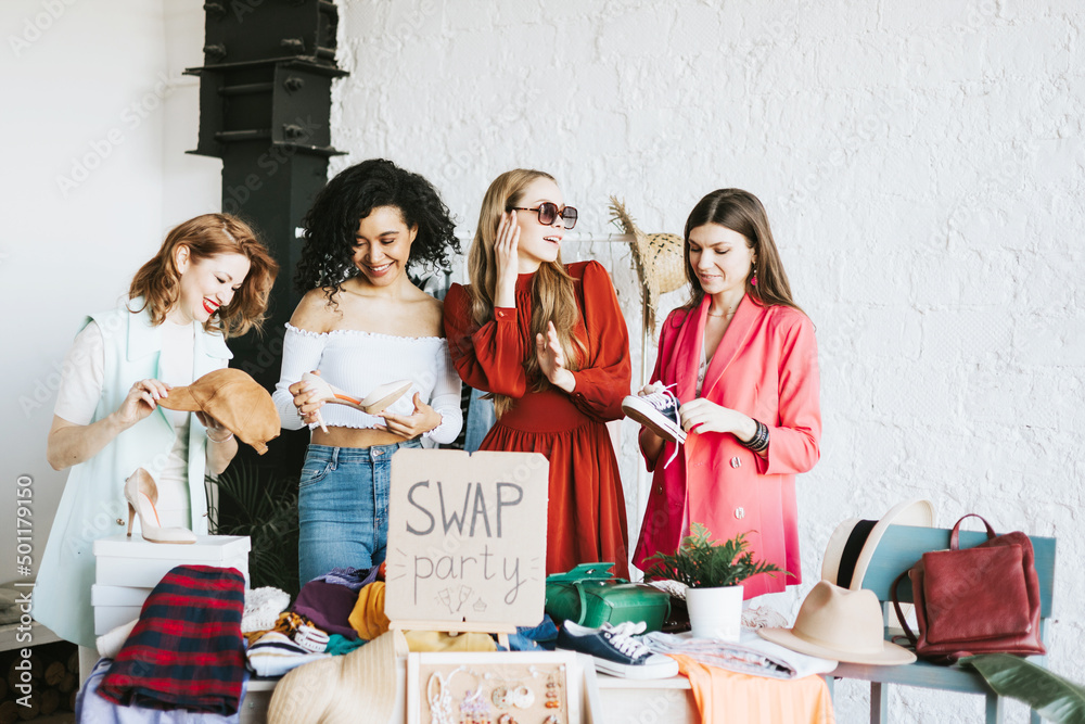 four young woman female caucasian and african students at swap party ...