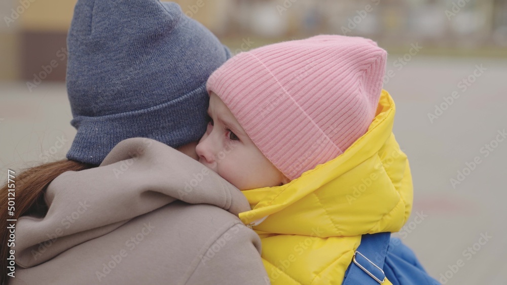 tears from wet eyes flow from the little child, the mother soothes and ...