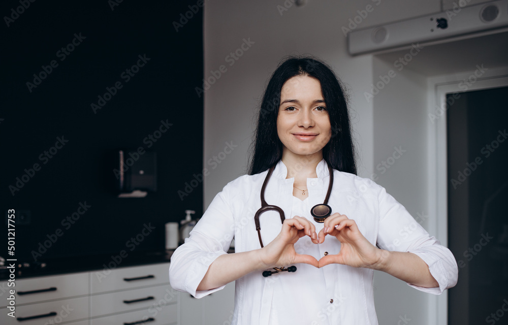 Smiling beautiful young indian ethnicity female doctor cardiologist ...