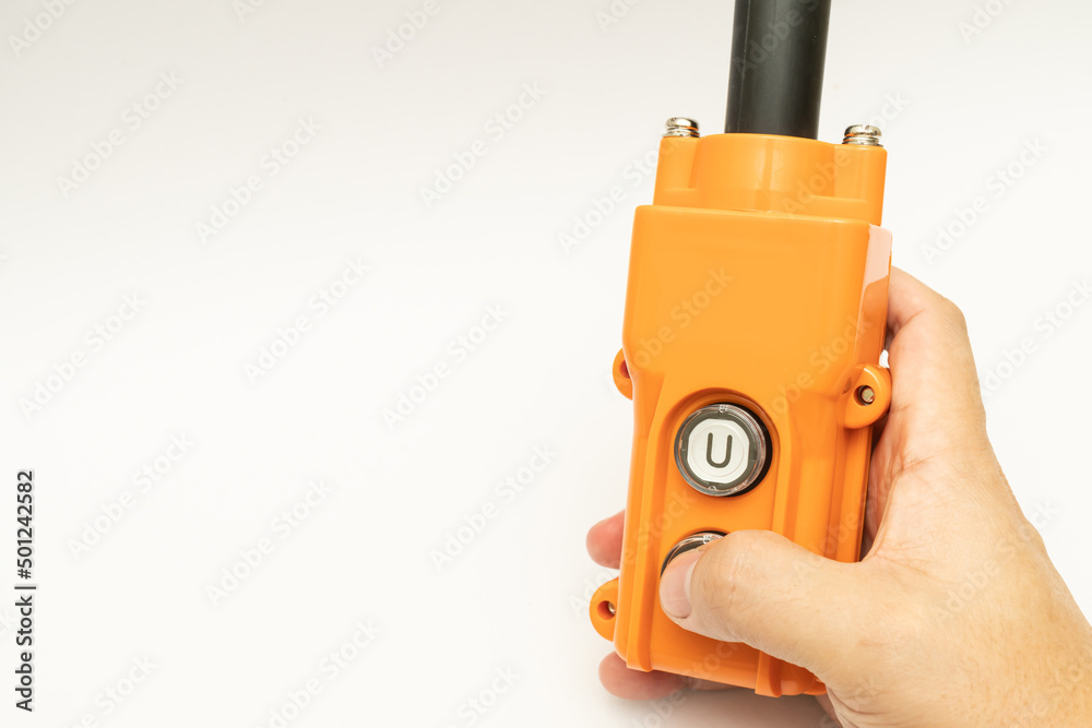 Hoist push button switch in isolated. hand holding overhead cranes ...