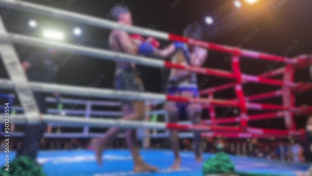 Blurred motion background youth amateur Muay Thai Boxing match kick ...