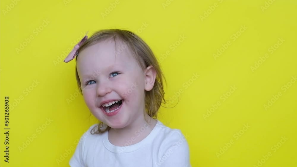 Funny little girl kid smiling while looking at camera and zooms in and ...