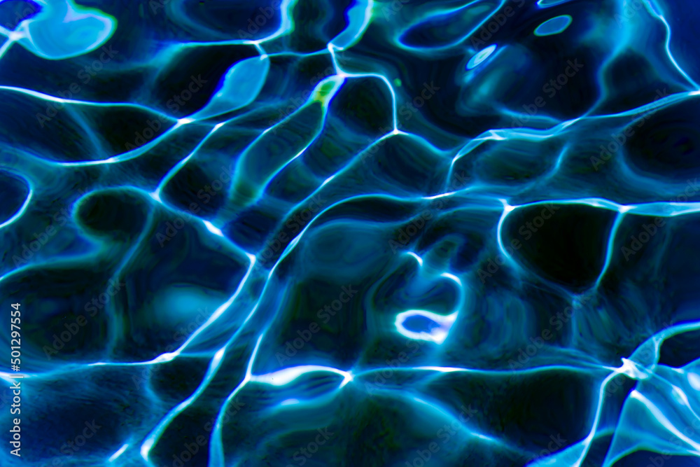 Dark blue water with sunlight reflections texture background. Ripples ...