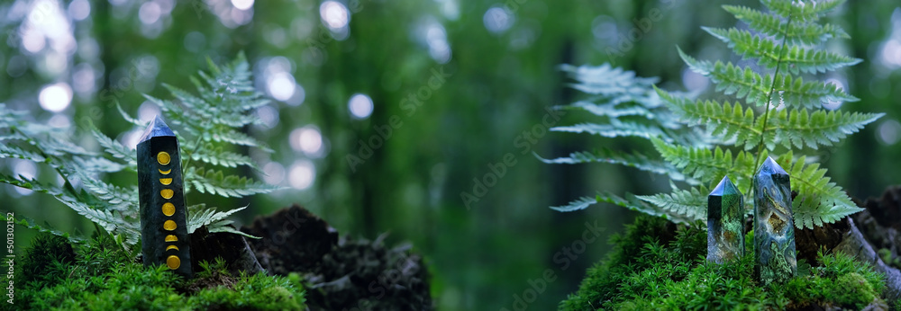 Crystals quartz towers on moss in forest, natural green background ...