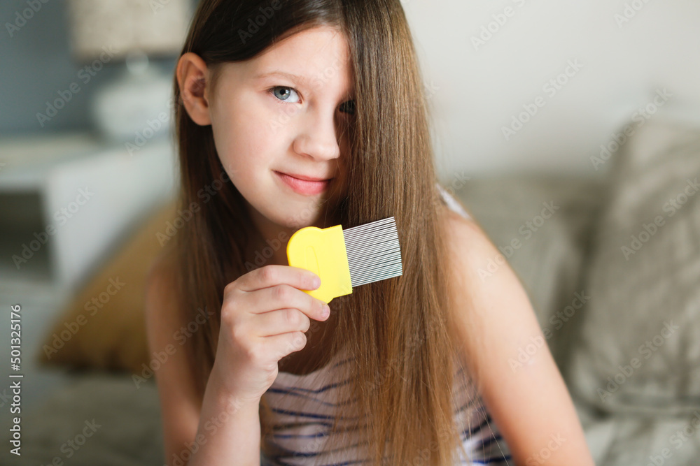 Long-haired European girl child with lice comb, protection. Health and ...