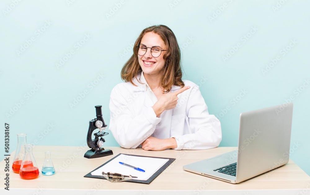 young pretty woman looking excited and surprised pointing to the side ...