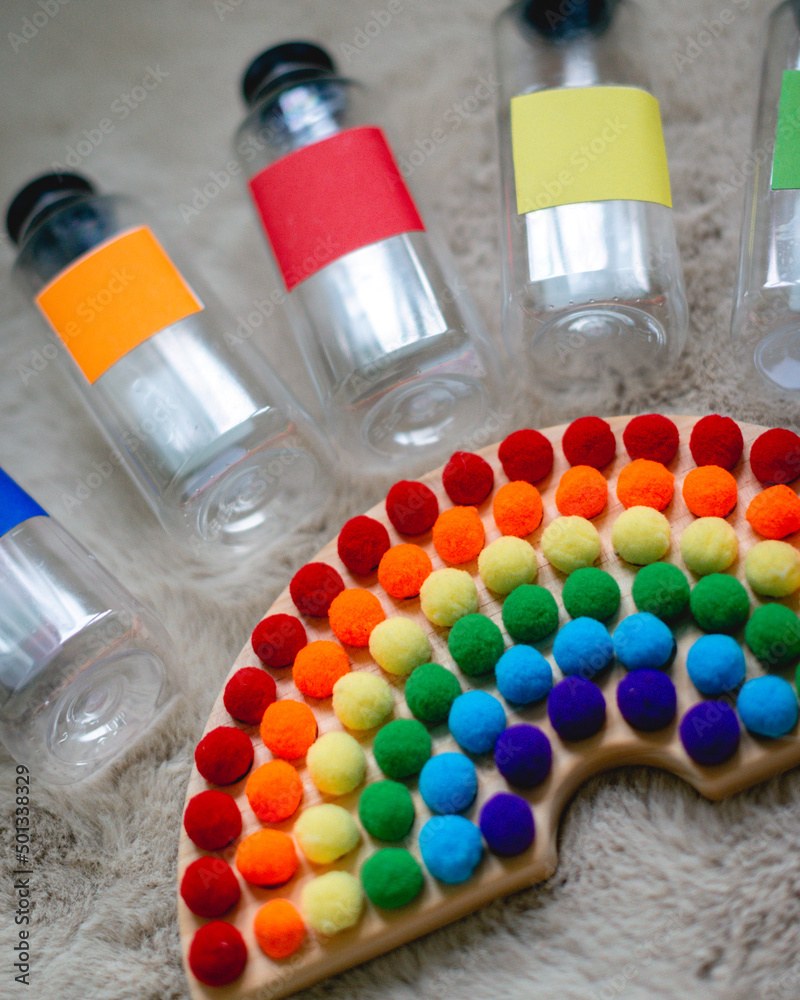 Rainbow sorting game with pom pom balls Stock Photo | Adobe Stock