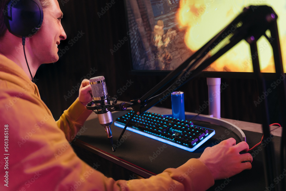 Young caucasian handsome pro gamer having live stream and playing in ...
