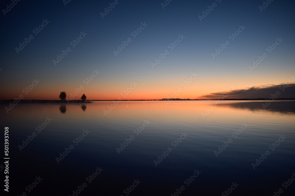 Mesmerizing view of trees with reflection in a lake during susnet in ...
